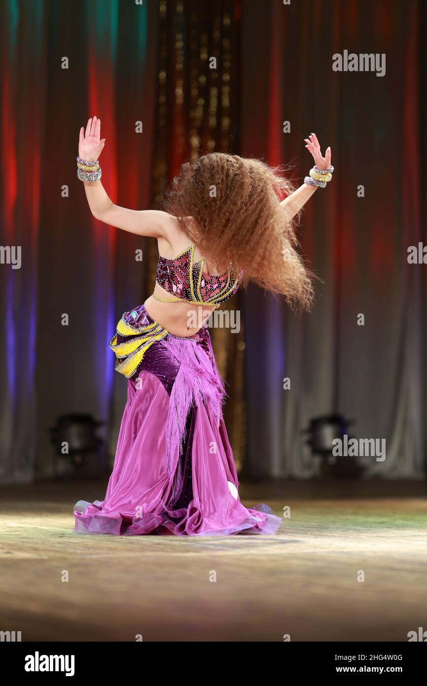 Girls dancers perform on stage with multi-colored lights. Backstage ...