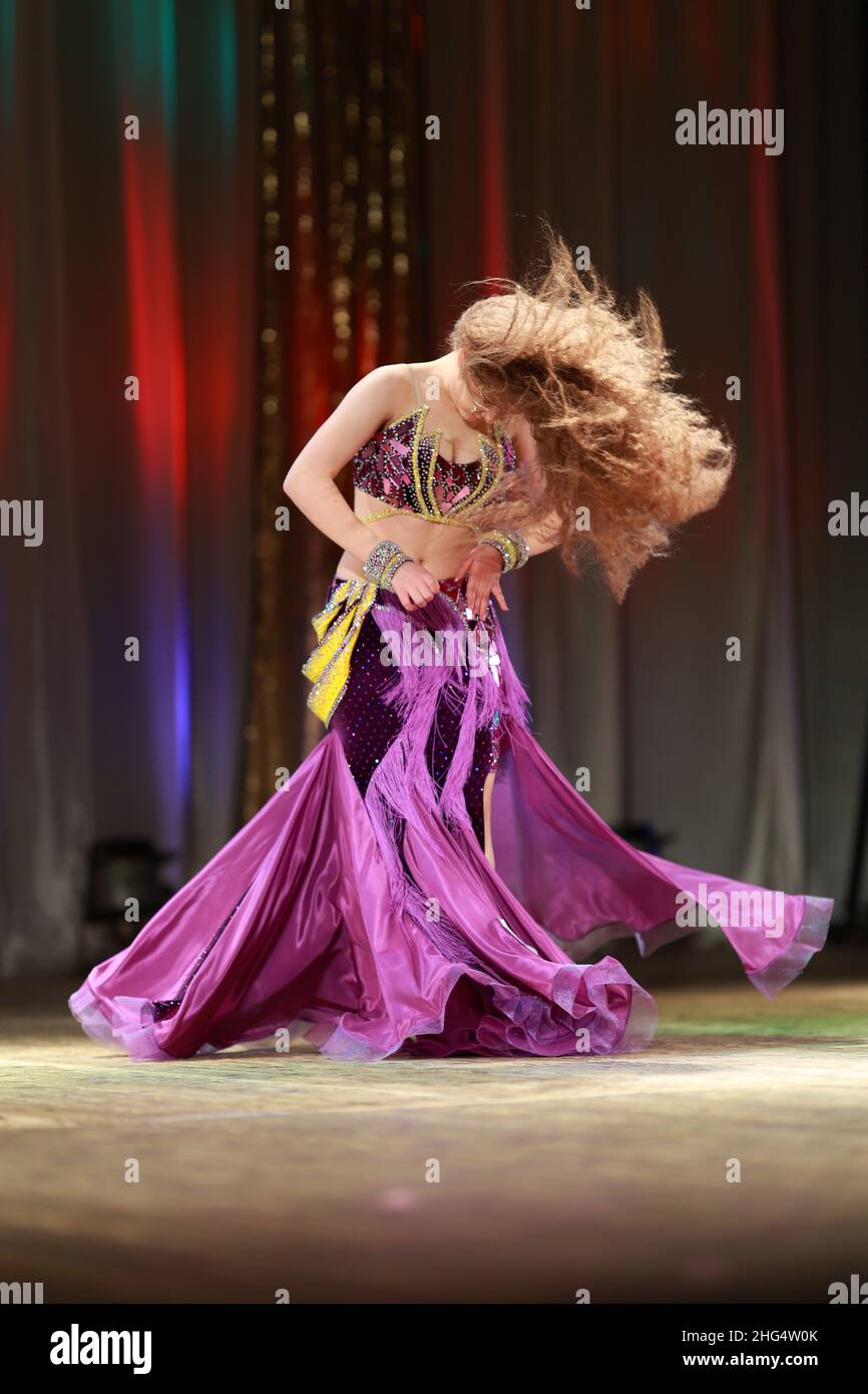 Girls dancers perform on stage with multi-colored lights. Backstage ...