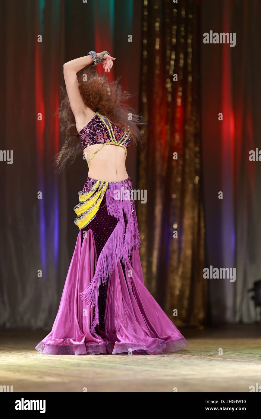 Girls dancers perform on stage with multi-colored lights. Backstage ...