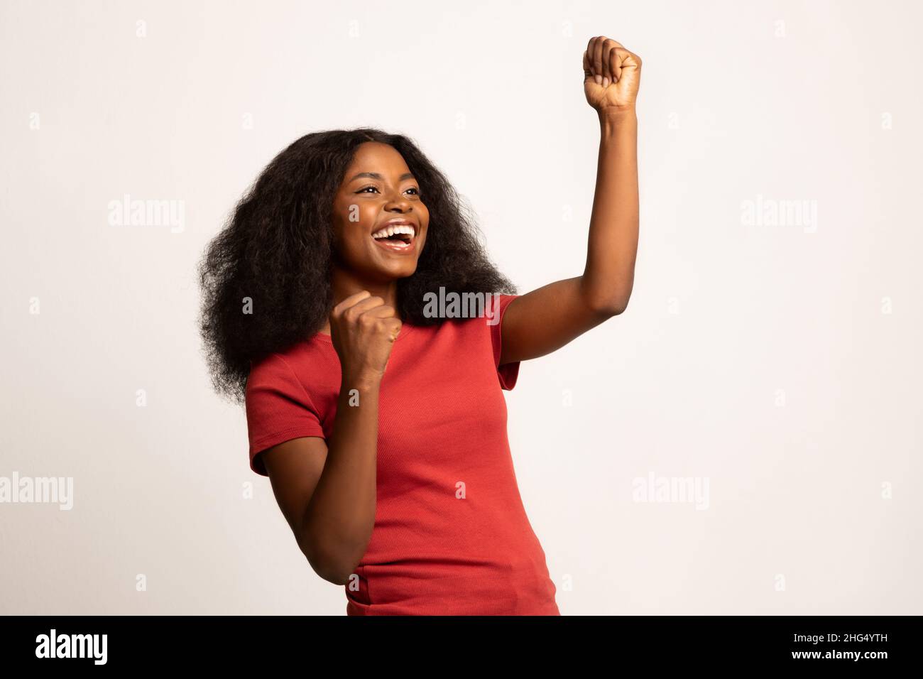 Overjoyed Black Woman Raising Clenched Fists And Exclaiming With ...