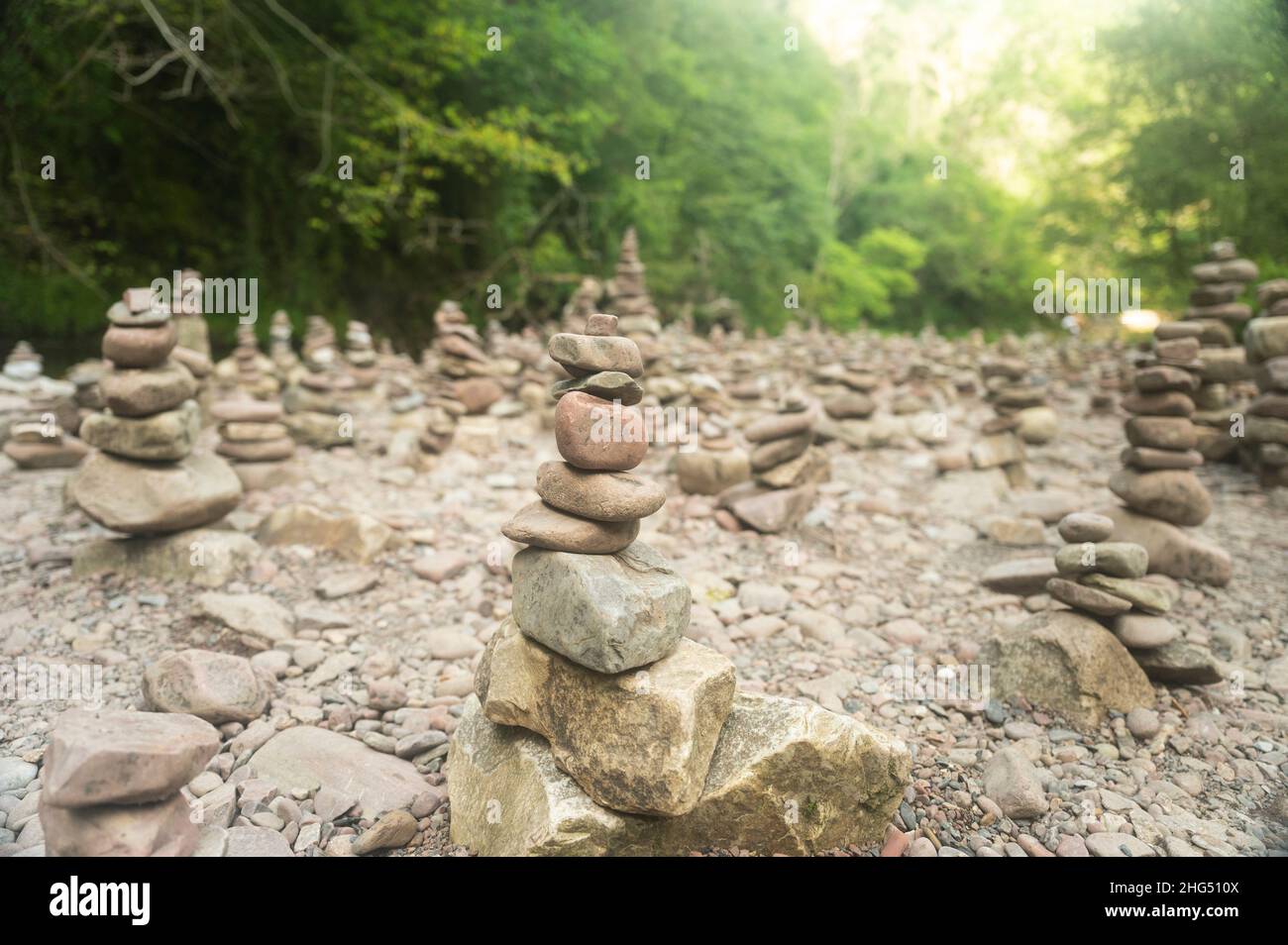 Endless amount of rock towers on the side of a stream Stock Photo - Alamy