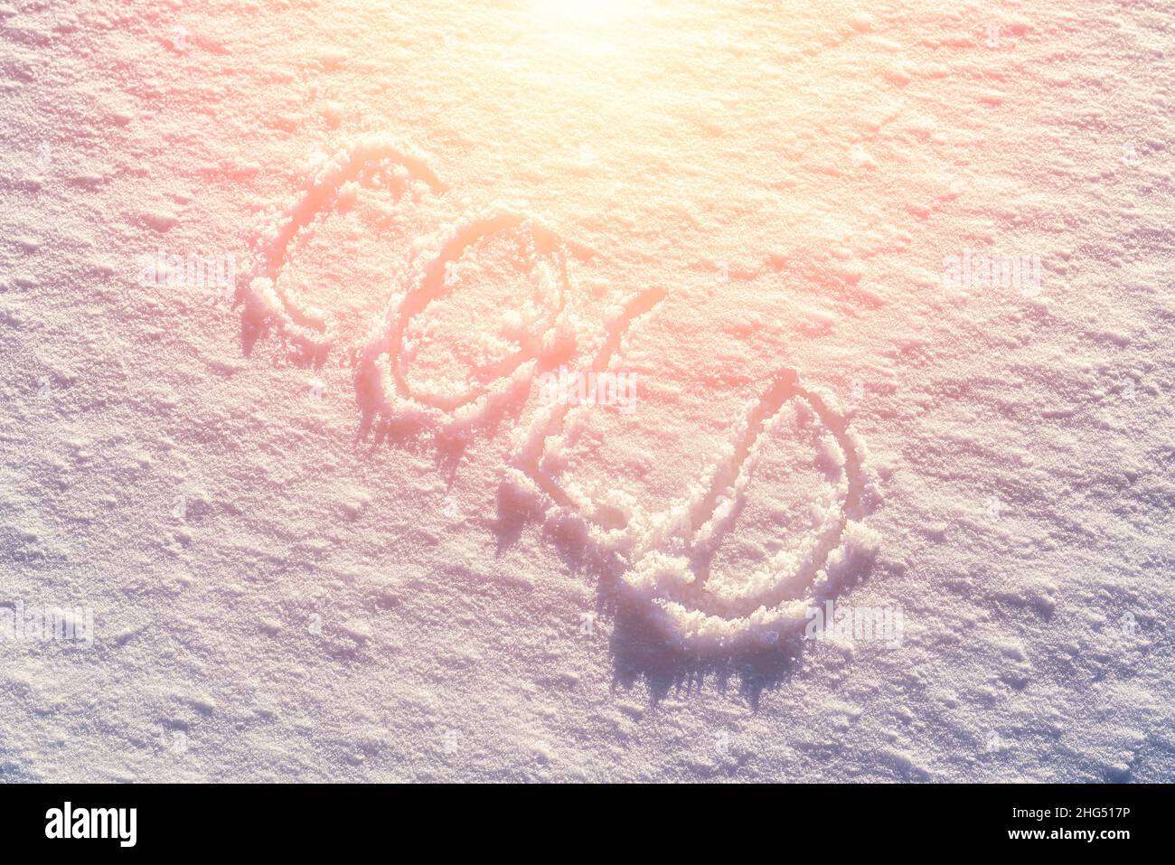 The word "cold" written on the snow in sunny weather. Winter and cold ...