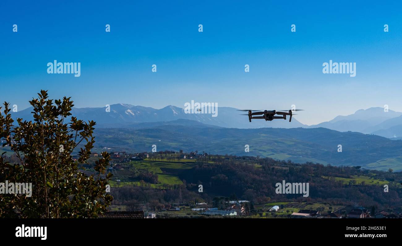 drone in flight with flying bird and countryside on the bottom Stock ...