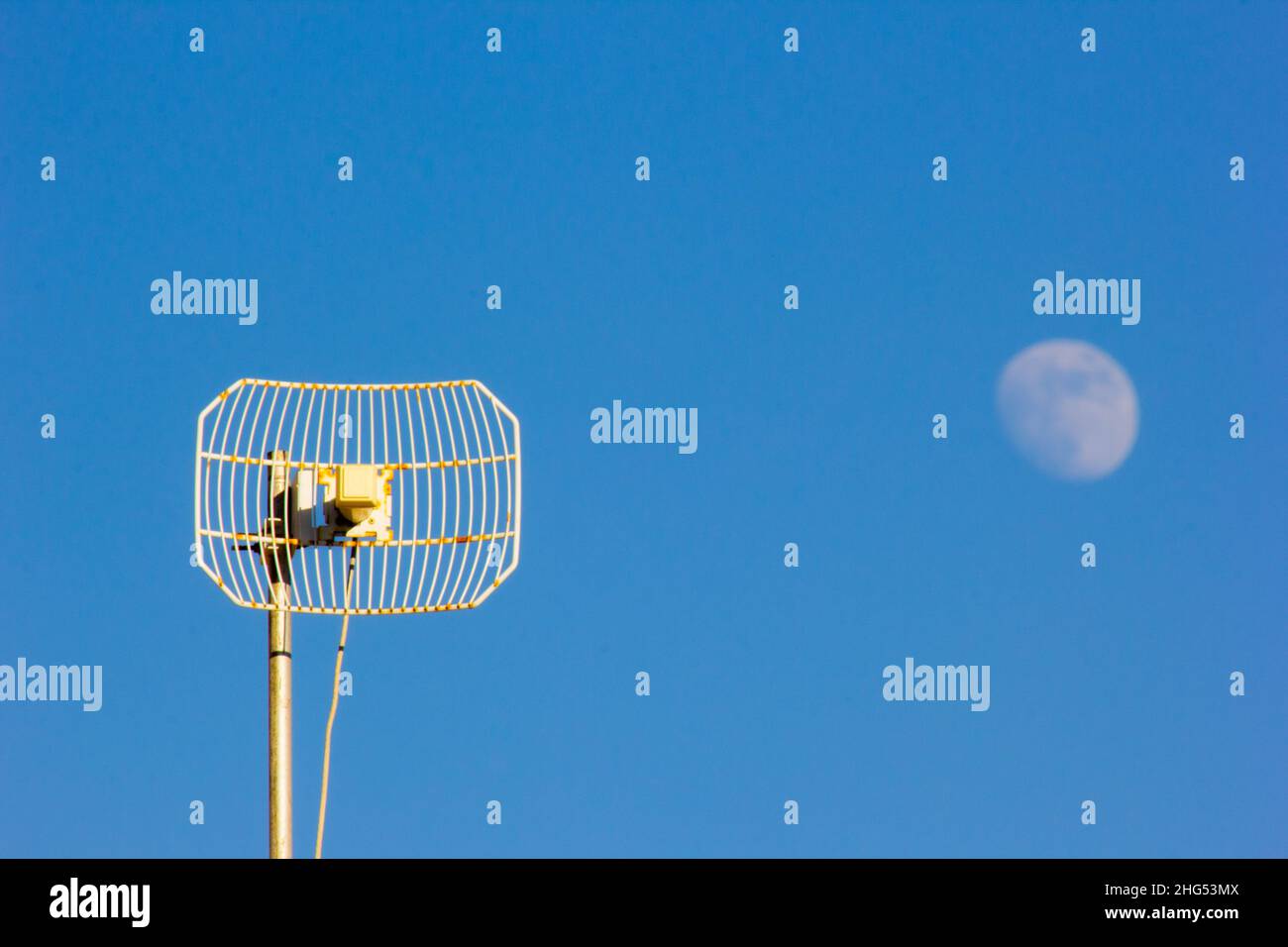 old television antenna with moon in the background and blue sky Stock ...