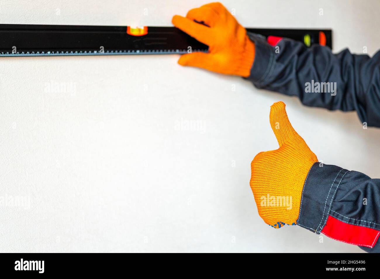 Worker's hands with bubble level. measuring with bubble level ...