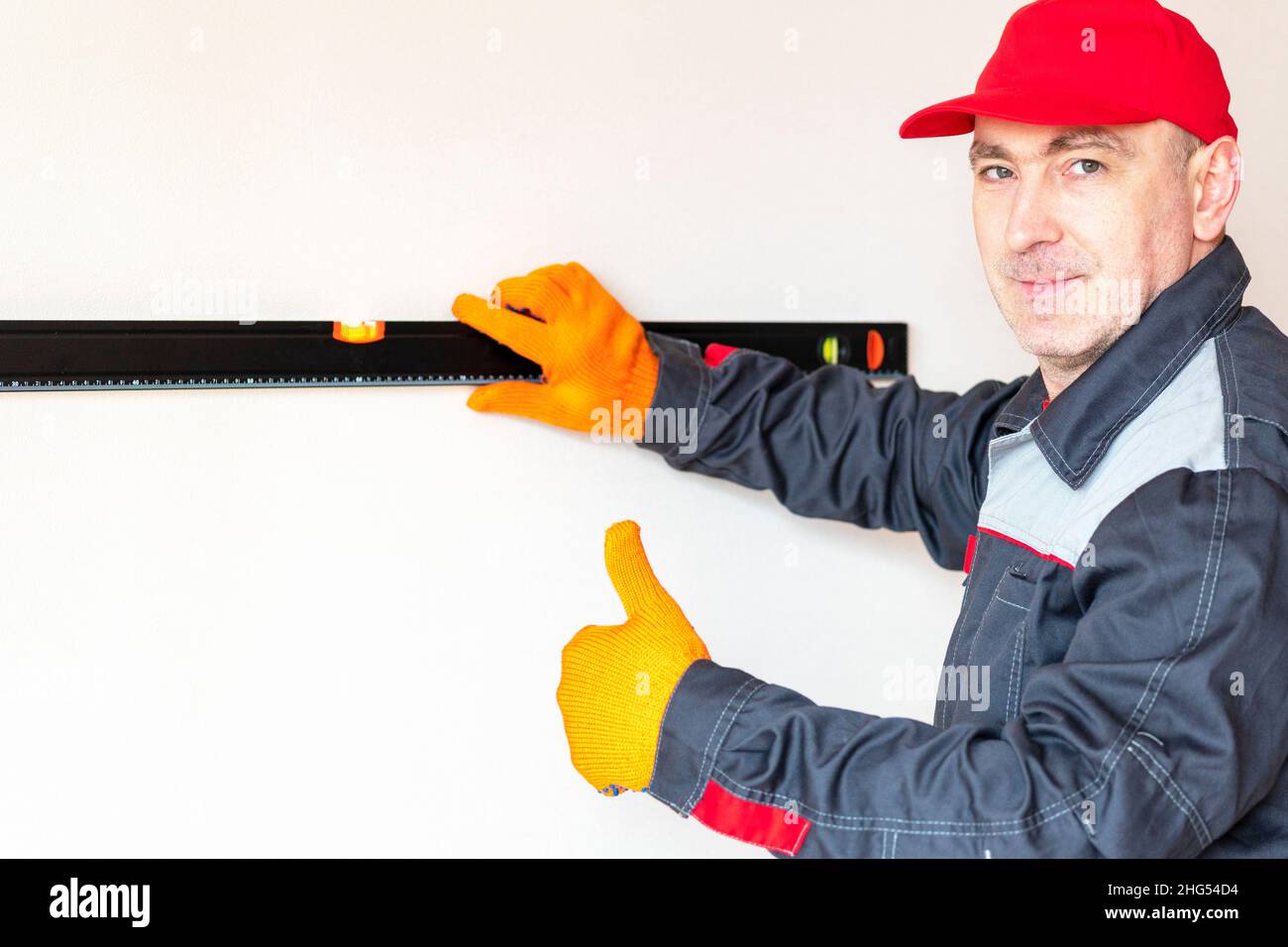 Worker with bubble level. measuring with bubble level.Measurement ...