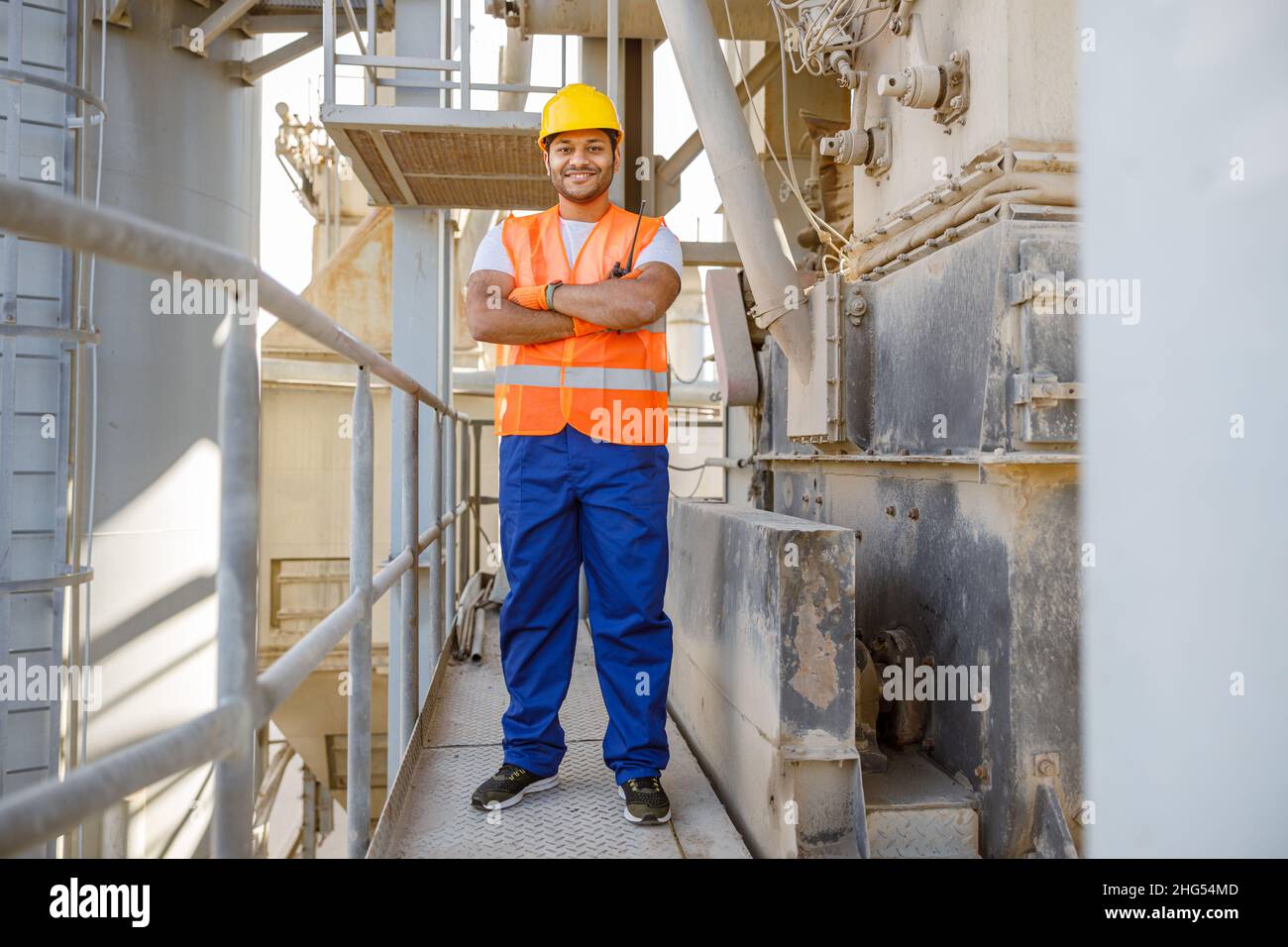 Happy African engineer standing at industrial site Stock Photo - Alamy