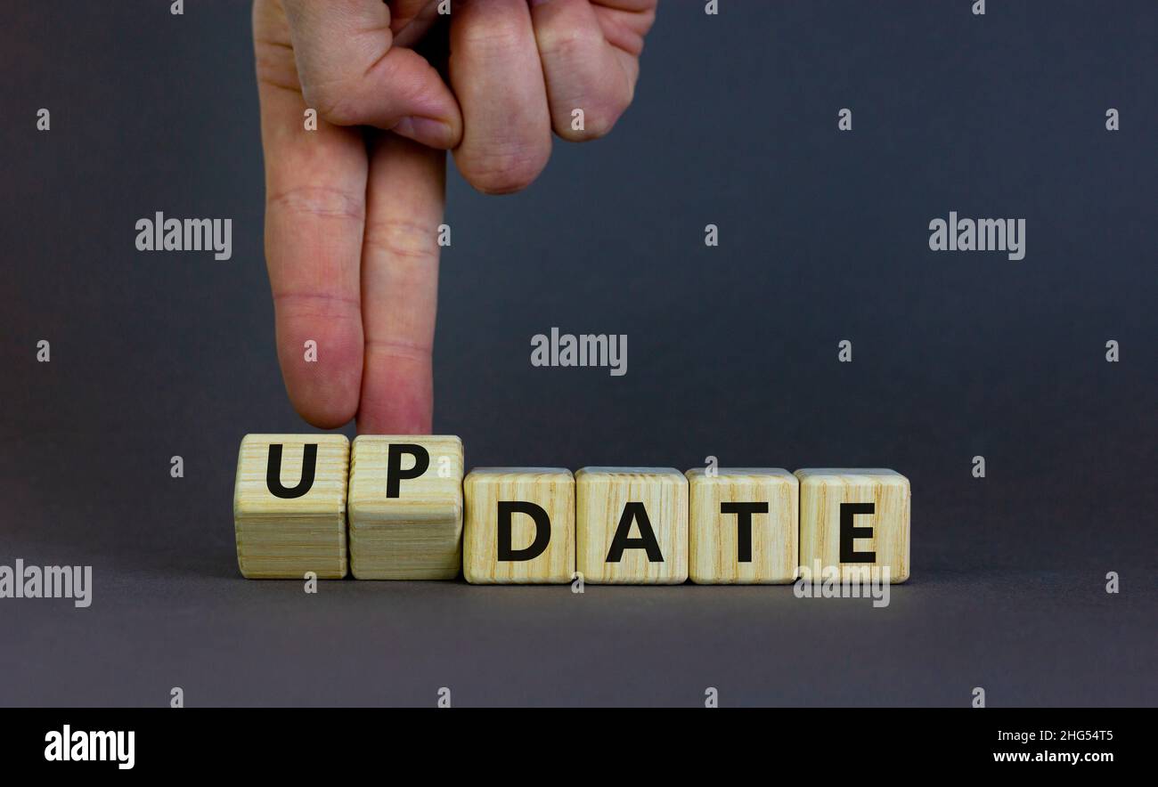 Date or update symbol. Businessman turns wooden cubes and changes the ...