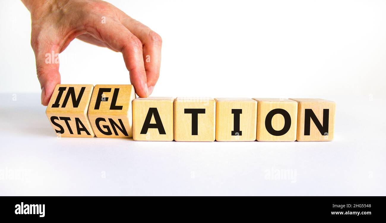 Inflation and stagnation symbol. Businessman turns cubes, changes the ...