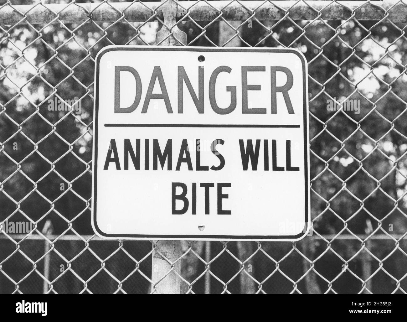 Danger animals bite warning sign Black and White Stock Photos & Images ...