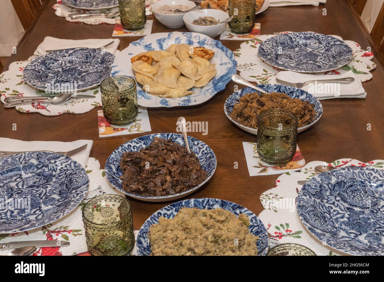 The Wigilia table is set with a white tablecloth under which is placed ...