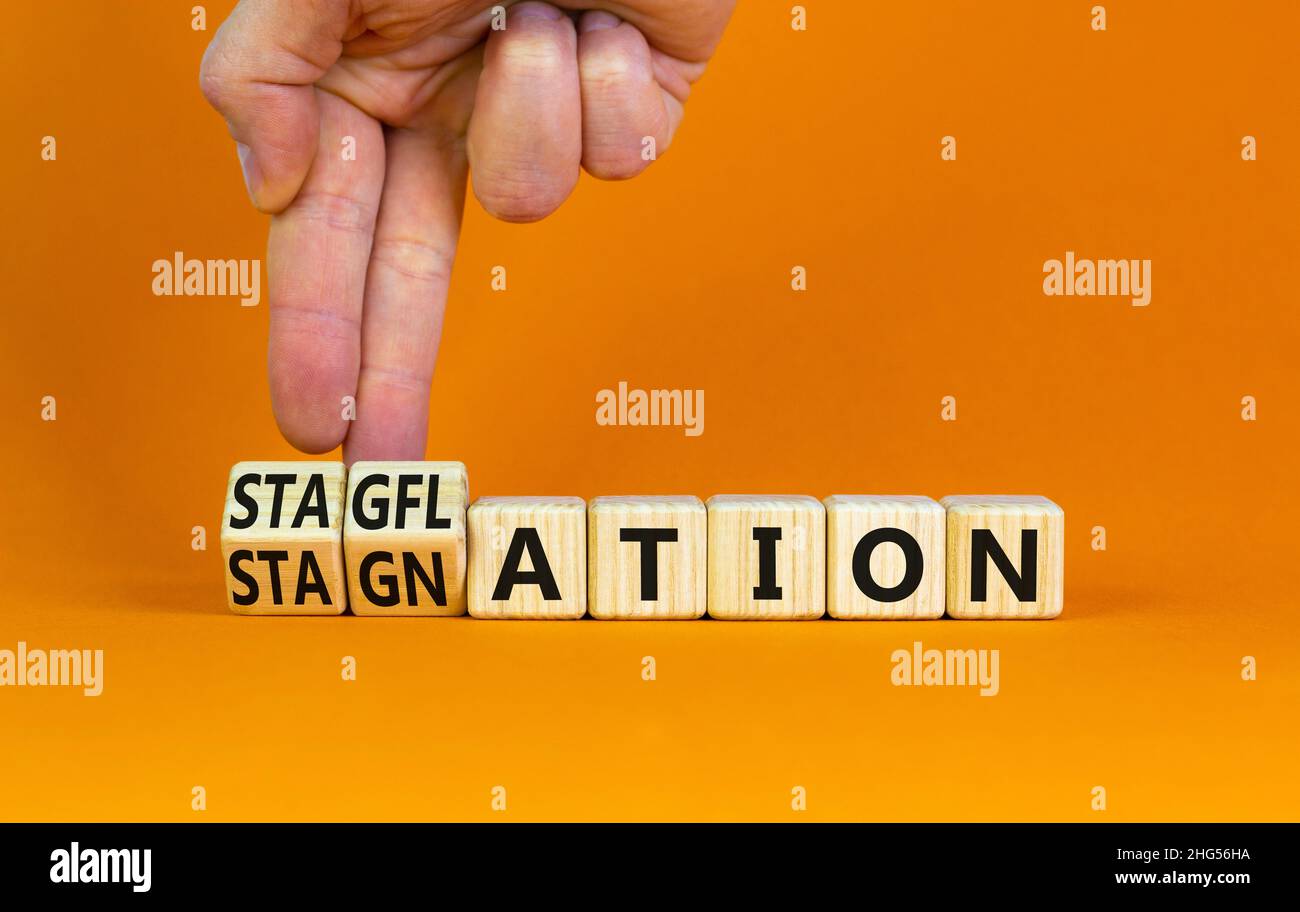 Stagflation or stagnation symbol. Businessman turns cubes, changes the ...