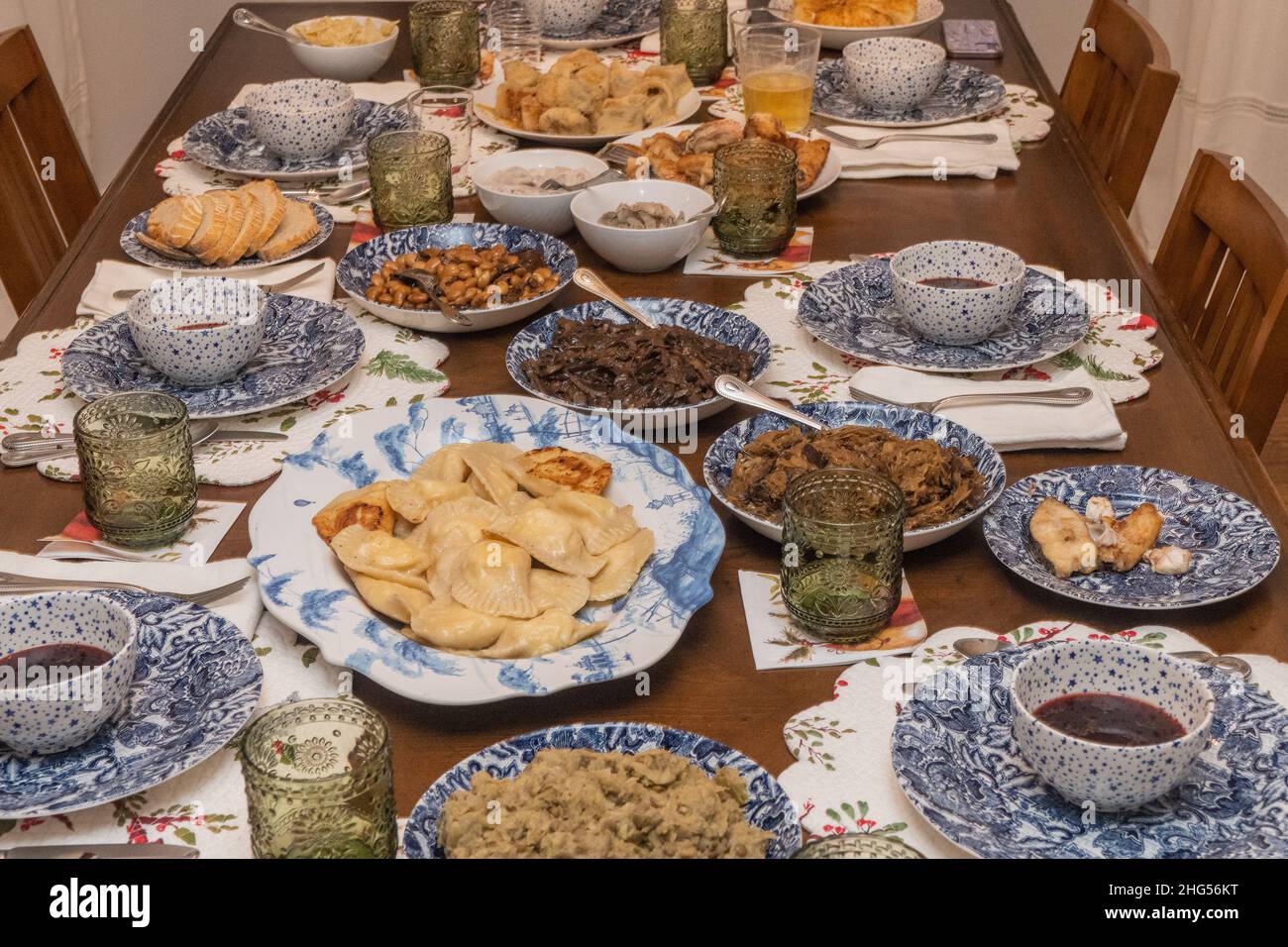The Wigilia table is set with a white tablecloth under which is placed ...