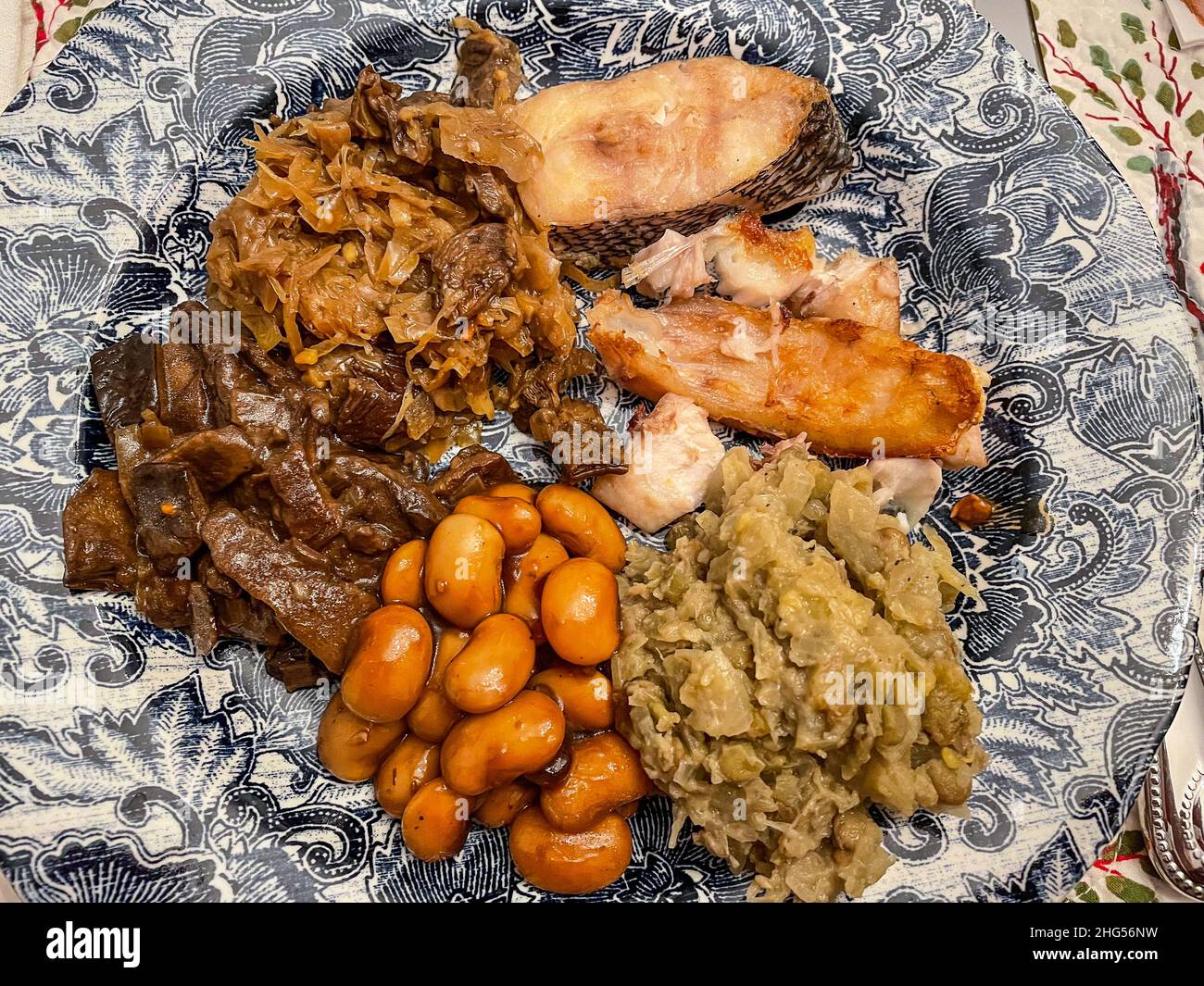 The Wigilia table is set with a white tablecloth under which is placed ...