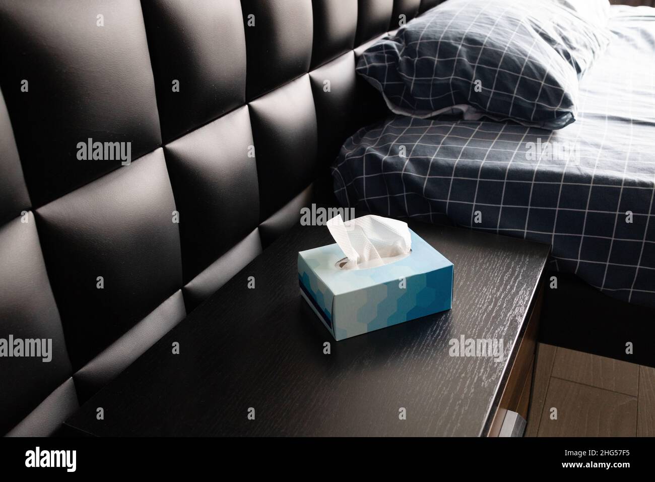 White tissue in blue paper box on the bedside table in the bedroom ...