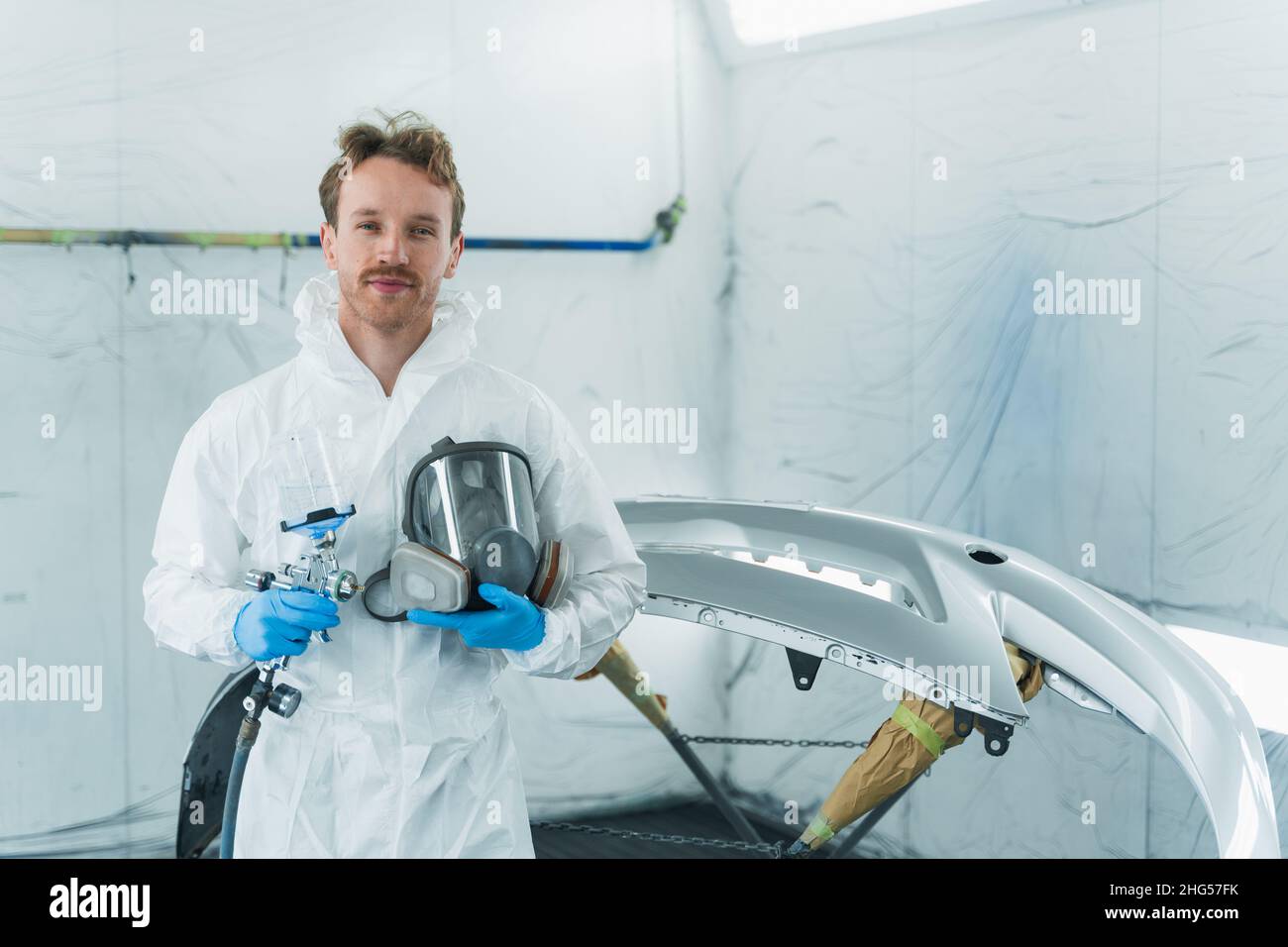 Portrait of a young car painter in a auto painting booth Stock Photo ...
