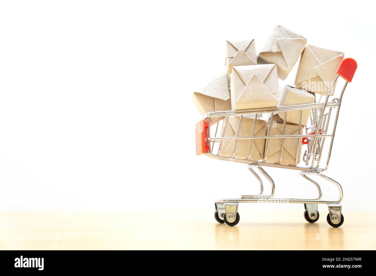 Miniature shopping trolley full of packages isolated on white ...