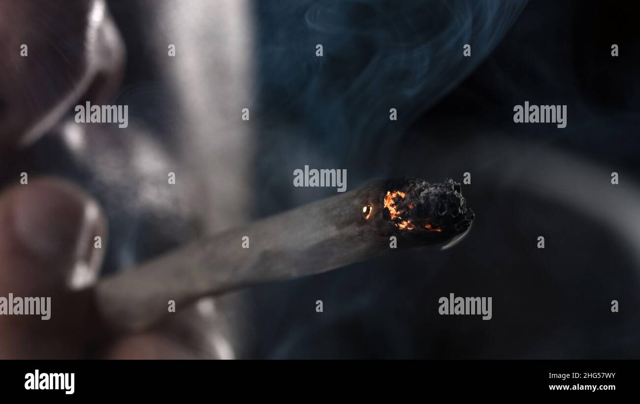 Cannabis joint holding lit hi-res stock photography and images - Alamy