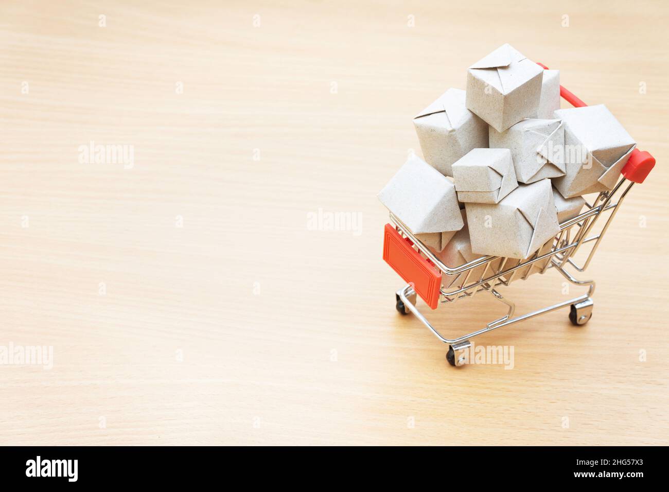 Top view of a miniature push cart full of craft paper packages on a ...