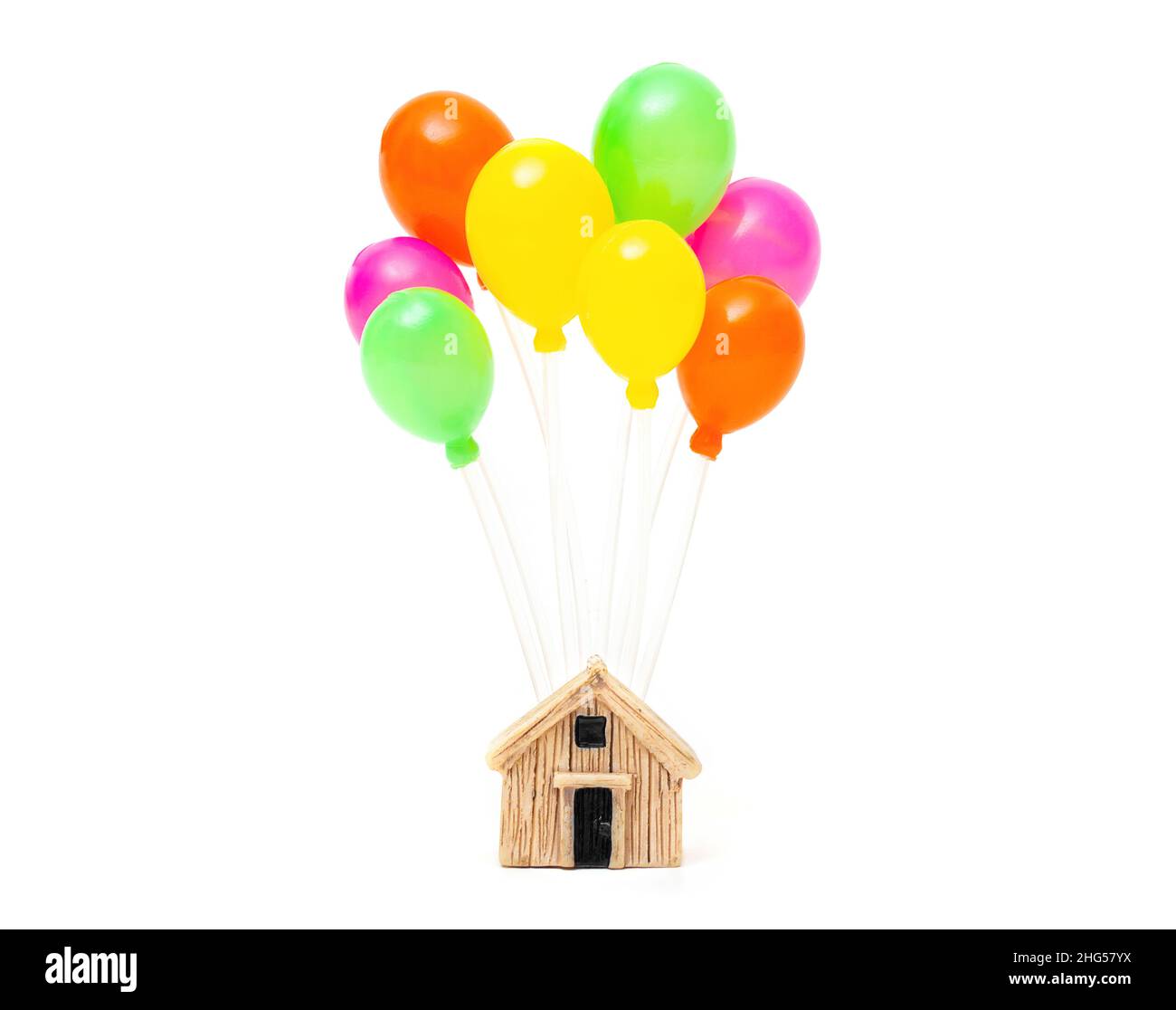 Tiny house model with a bunch of multicolored balloons isolated on a ...