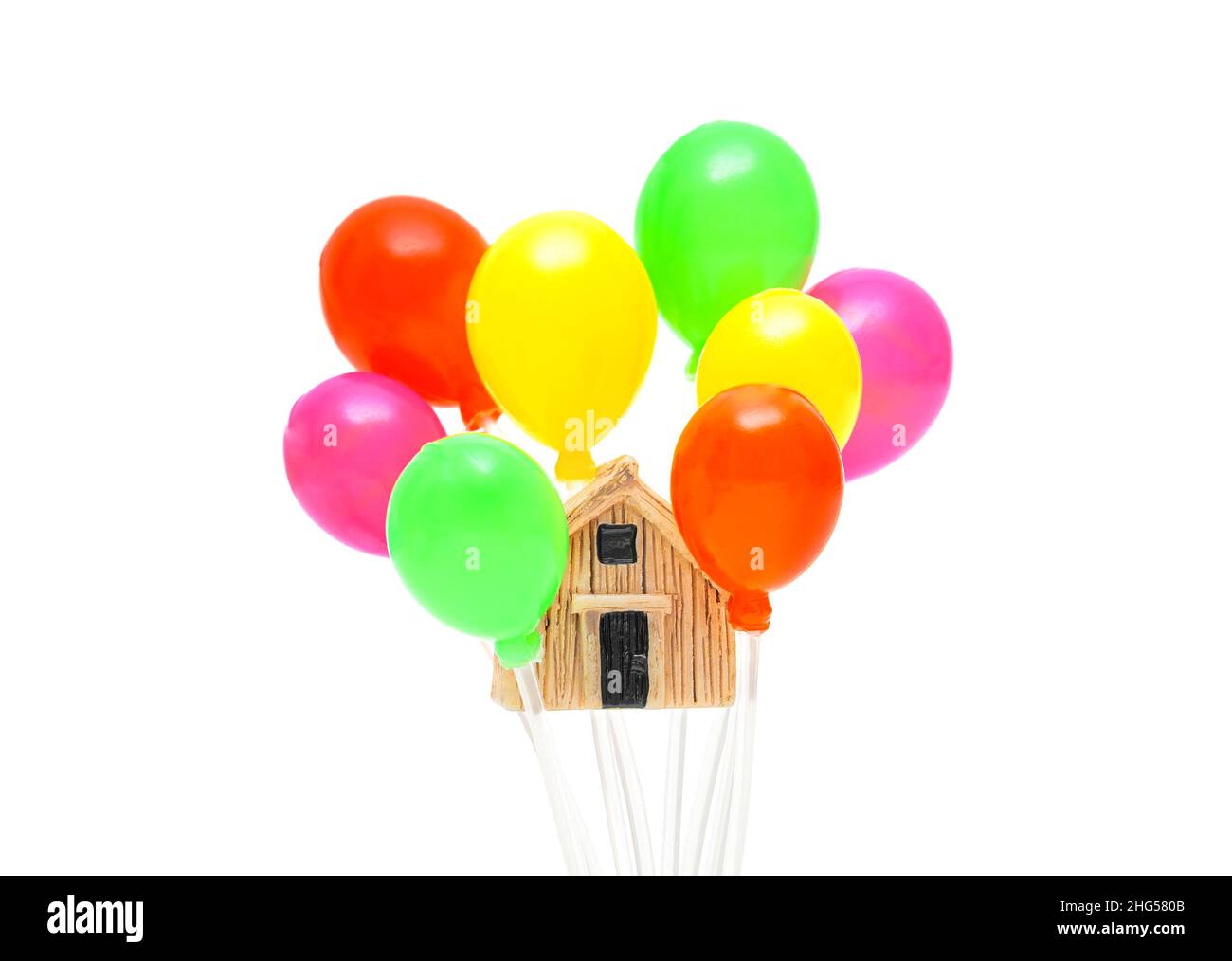 Small house model in a cluster of multicolored balloons isolated on a ...