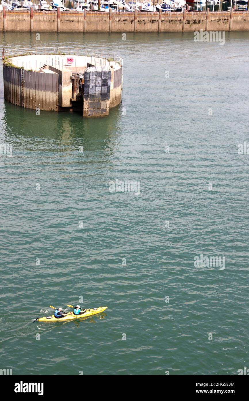 Plymouth harbour. Devon. Yellow canoe from elevated view.Couple ...
