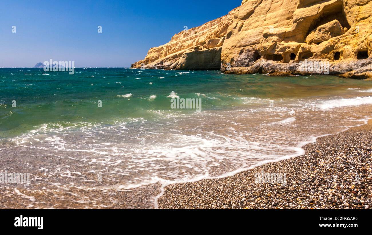 Matala beach and cliff with caves on the island of Crete, Greece Stock ...