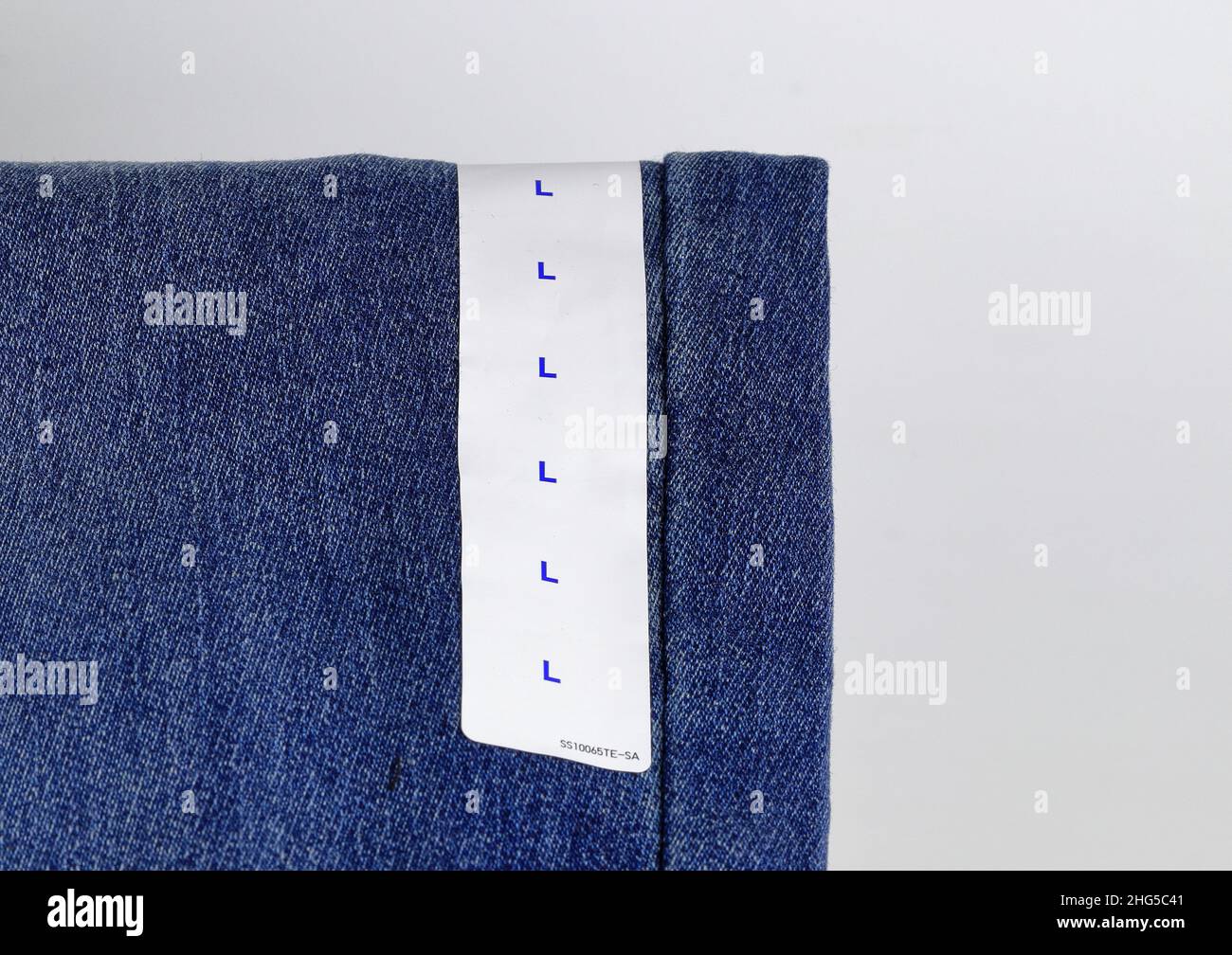 Blue jeans denim with label size, collection jeans stacked with label ...