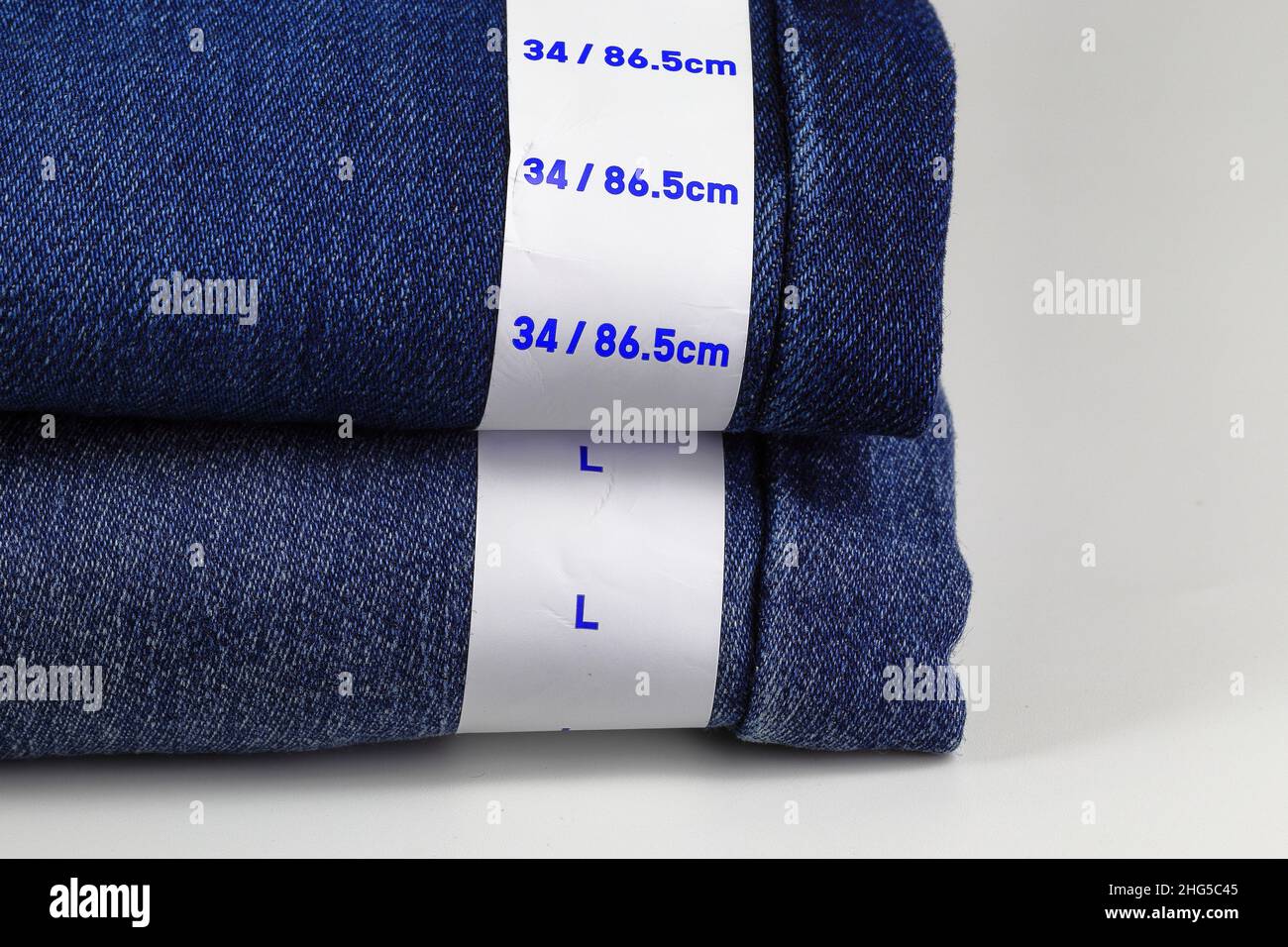 Blue jeans denim with label size, collection jeans stacked with label ...