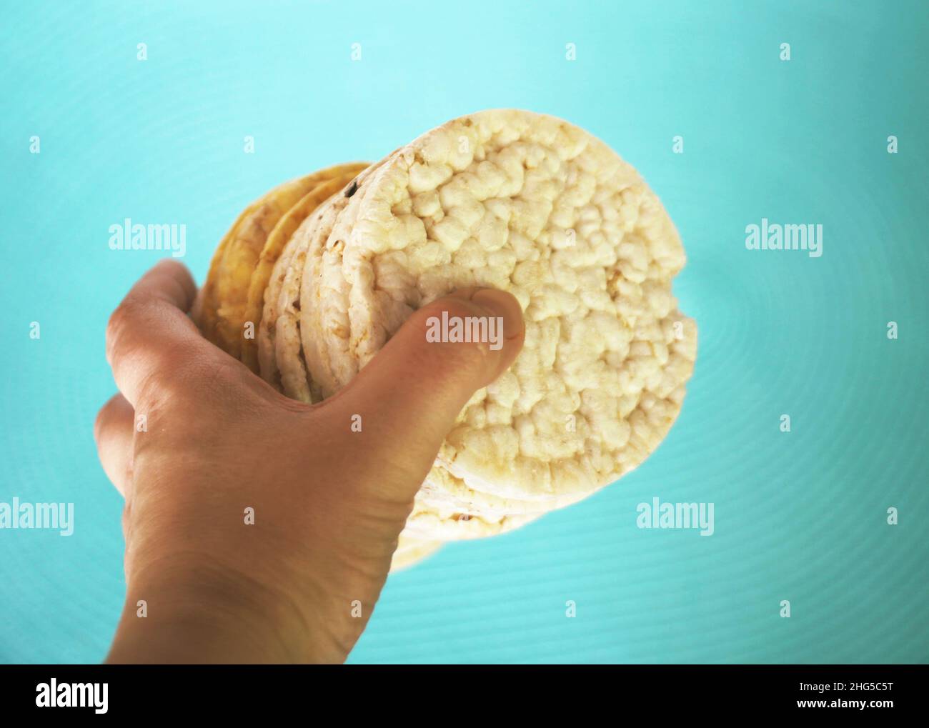 Flat round rice and corn white and yellow crackers on blue background ...