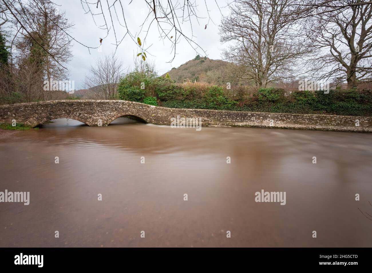 Long exposure of the river Avill flowing under Gallox bridge in Dunster ...