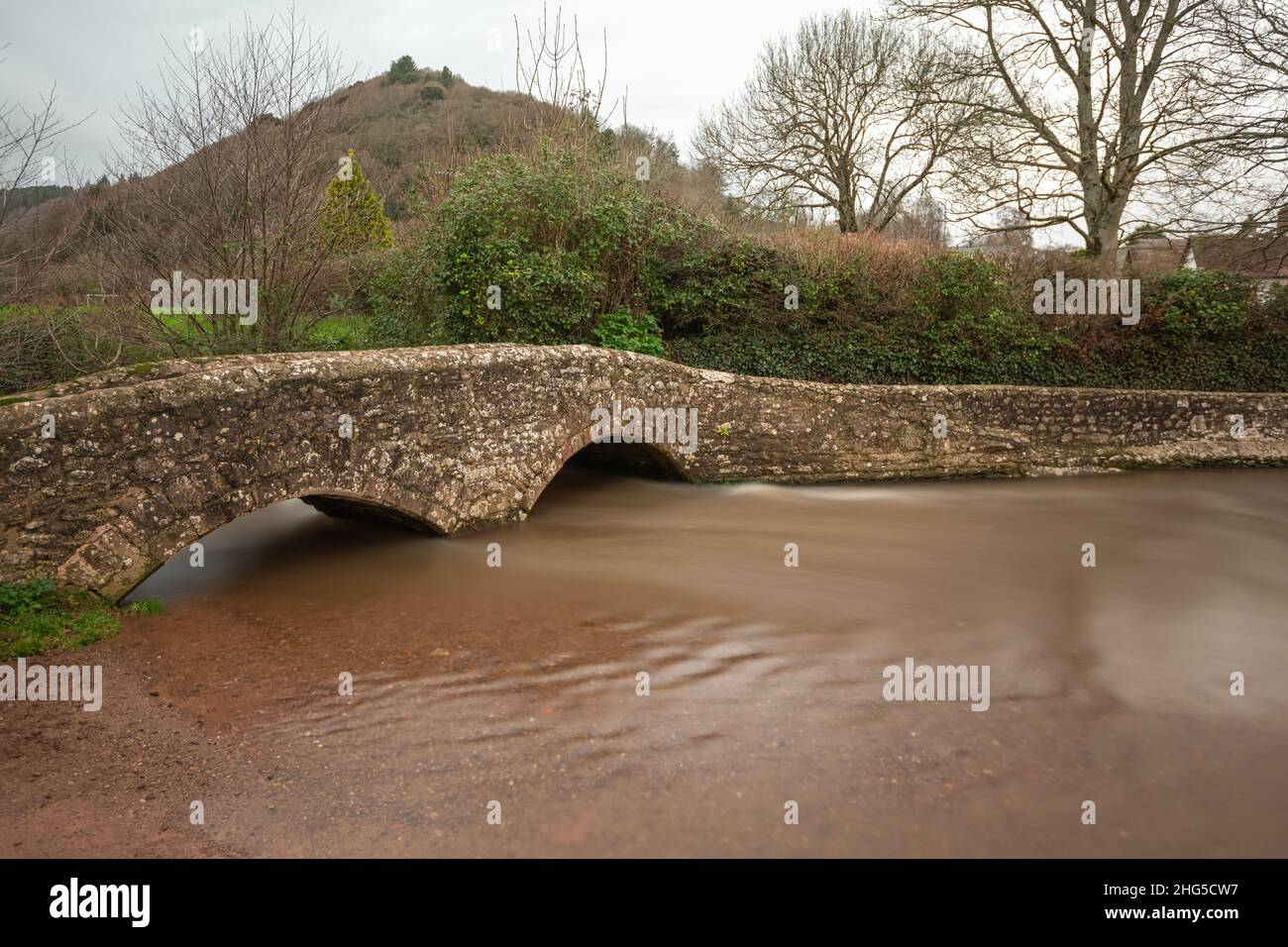 Long exposure of the river Avill flowing under Gallox bridge in Dunster ...