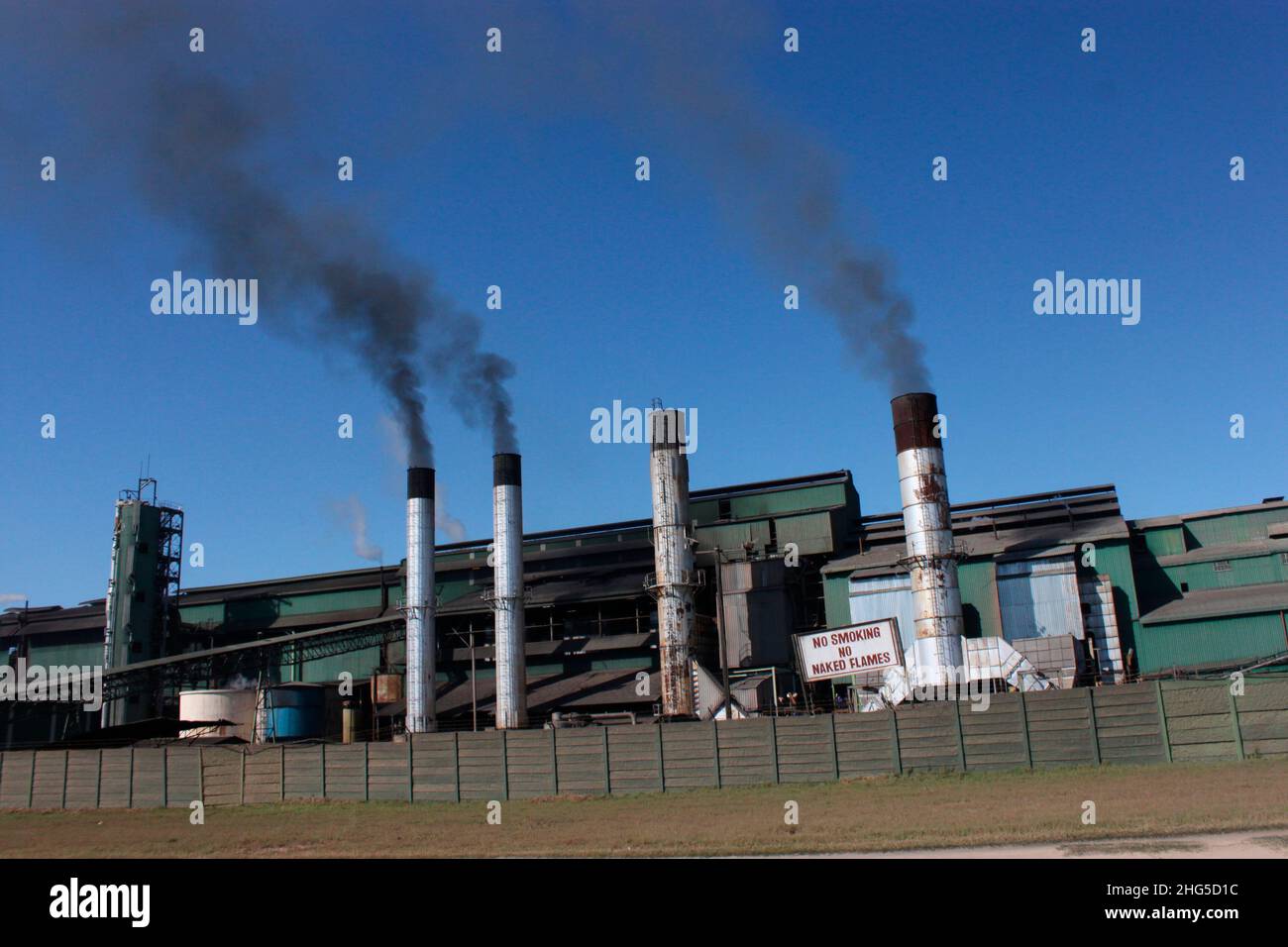 Smoke is seen from a sugar-processing plant in Chiredzi which is famous ...