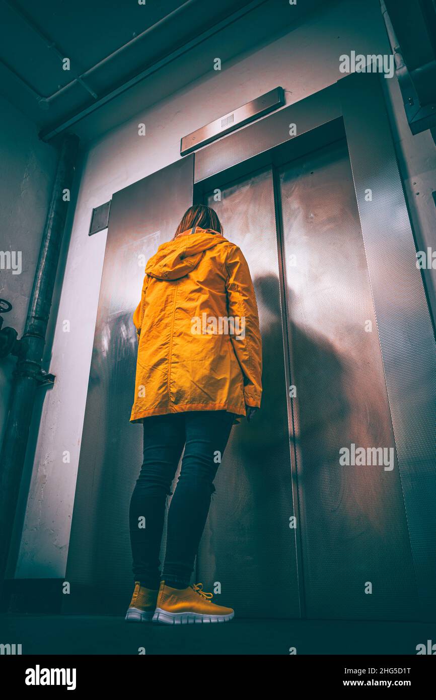 Woman waiting for elevator hi-res stock photography and images - Alamy