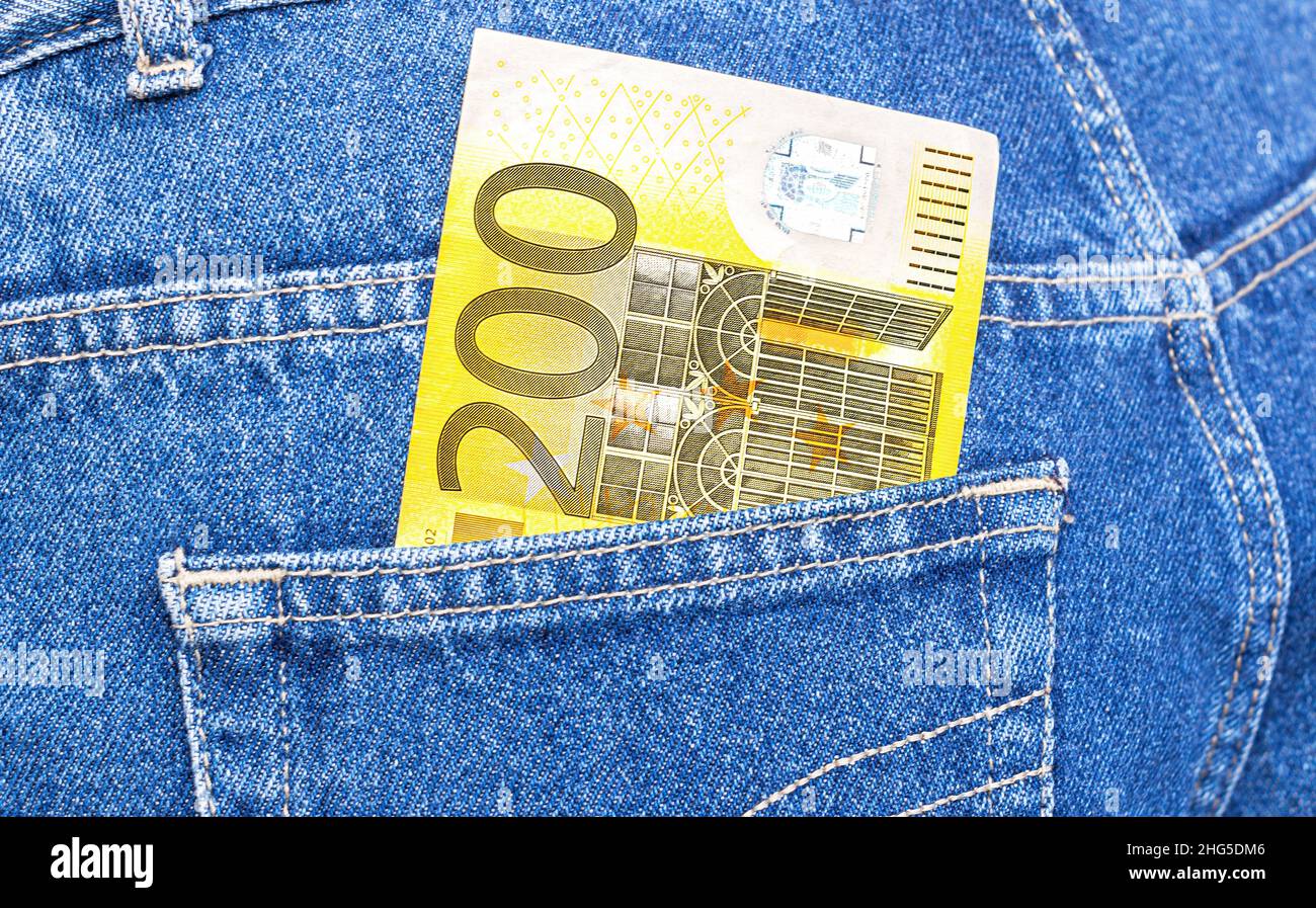Banknote 200 euro sticking out of the blue jeans pocket close up Stock ...