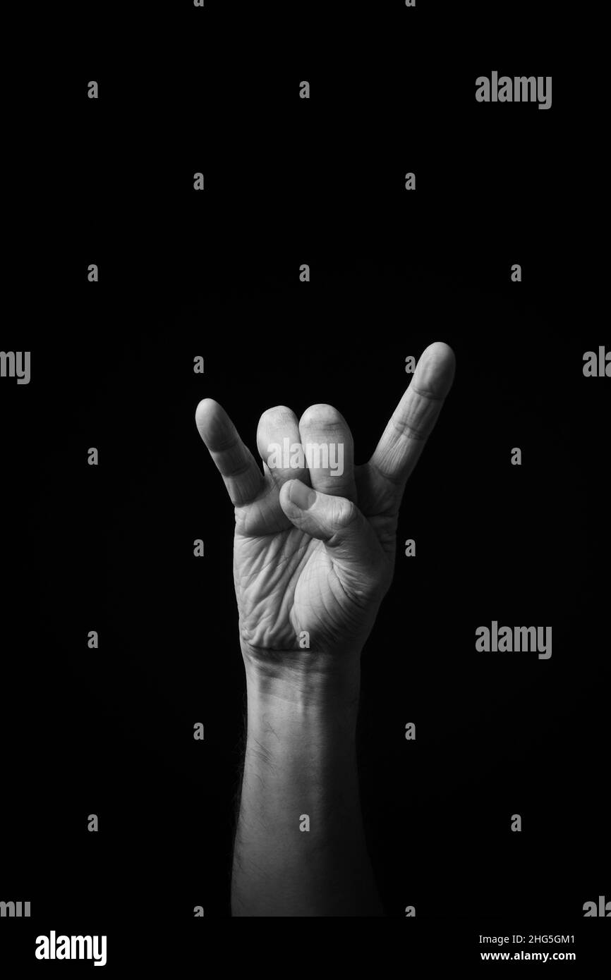 Dramatic B+W image of male hand fingerspelling CSL Chinese sign ...