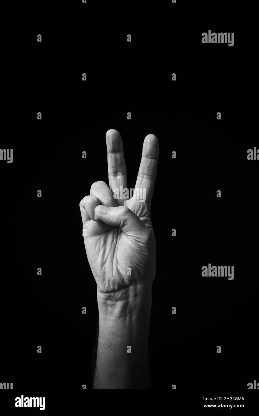 Dramatic B+W image of male hand fingerspelling CSL Chinese sign ...