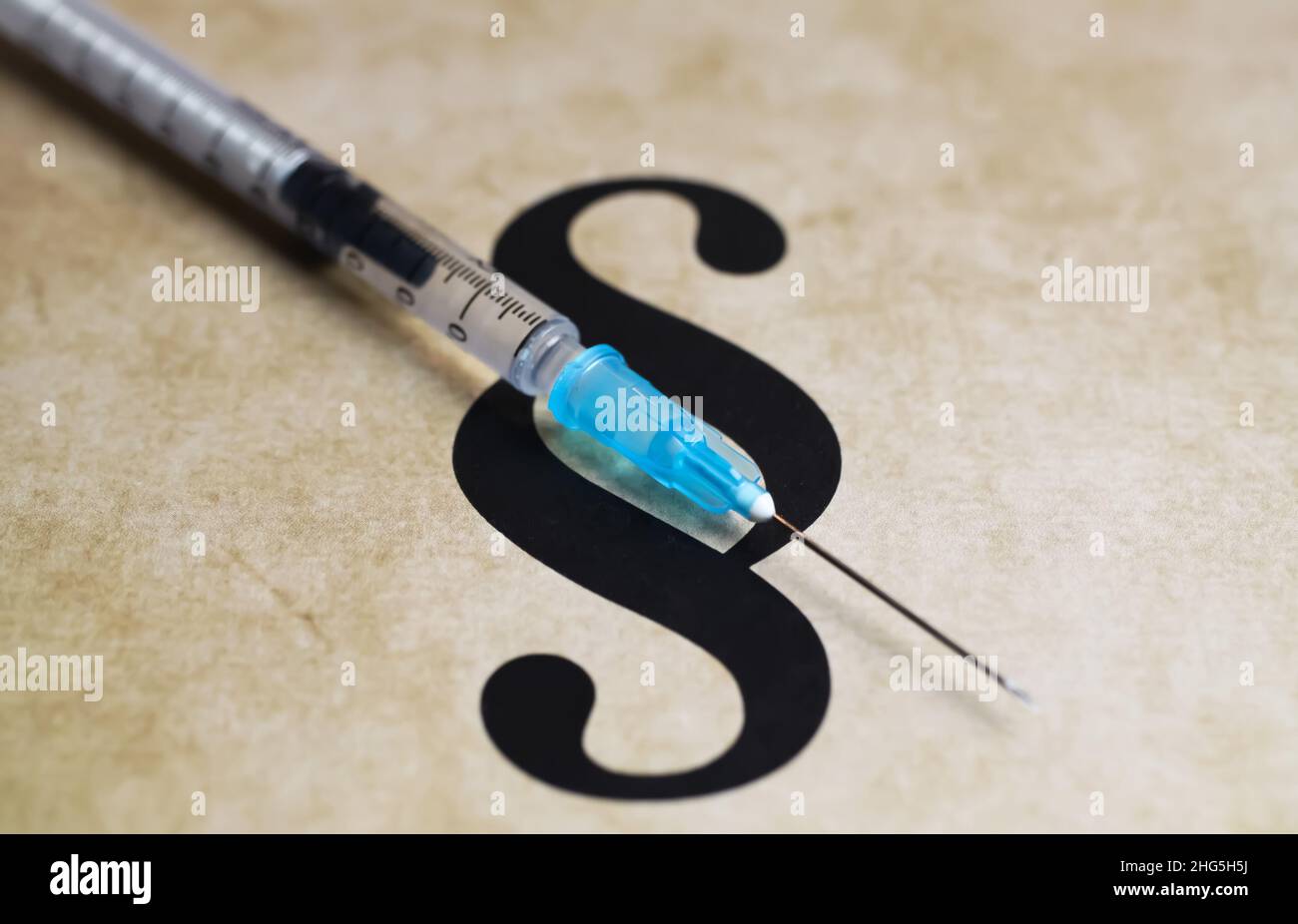 Closeup of paragraph symbol with vaccination syringe - euthanasia ...