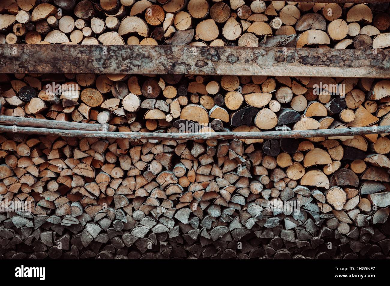 Wood natural sawn logs as background. Stacked wall wood logs. Stacked ...