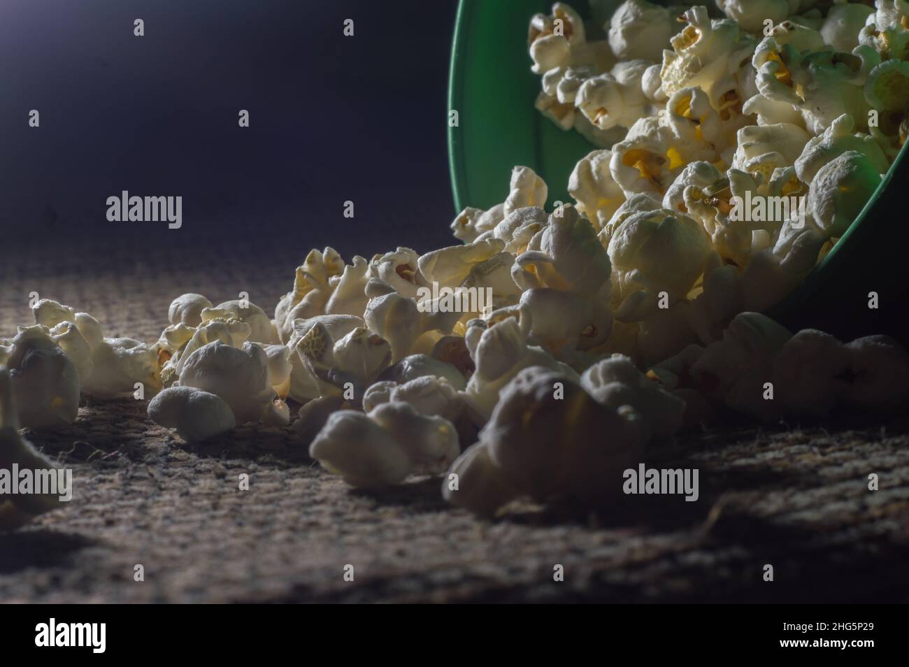 popcorn dropped on the sofa with copy space and dark background Stock ...