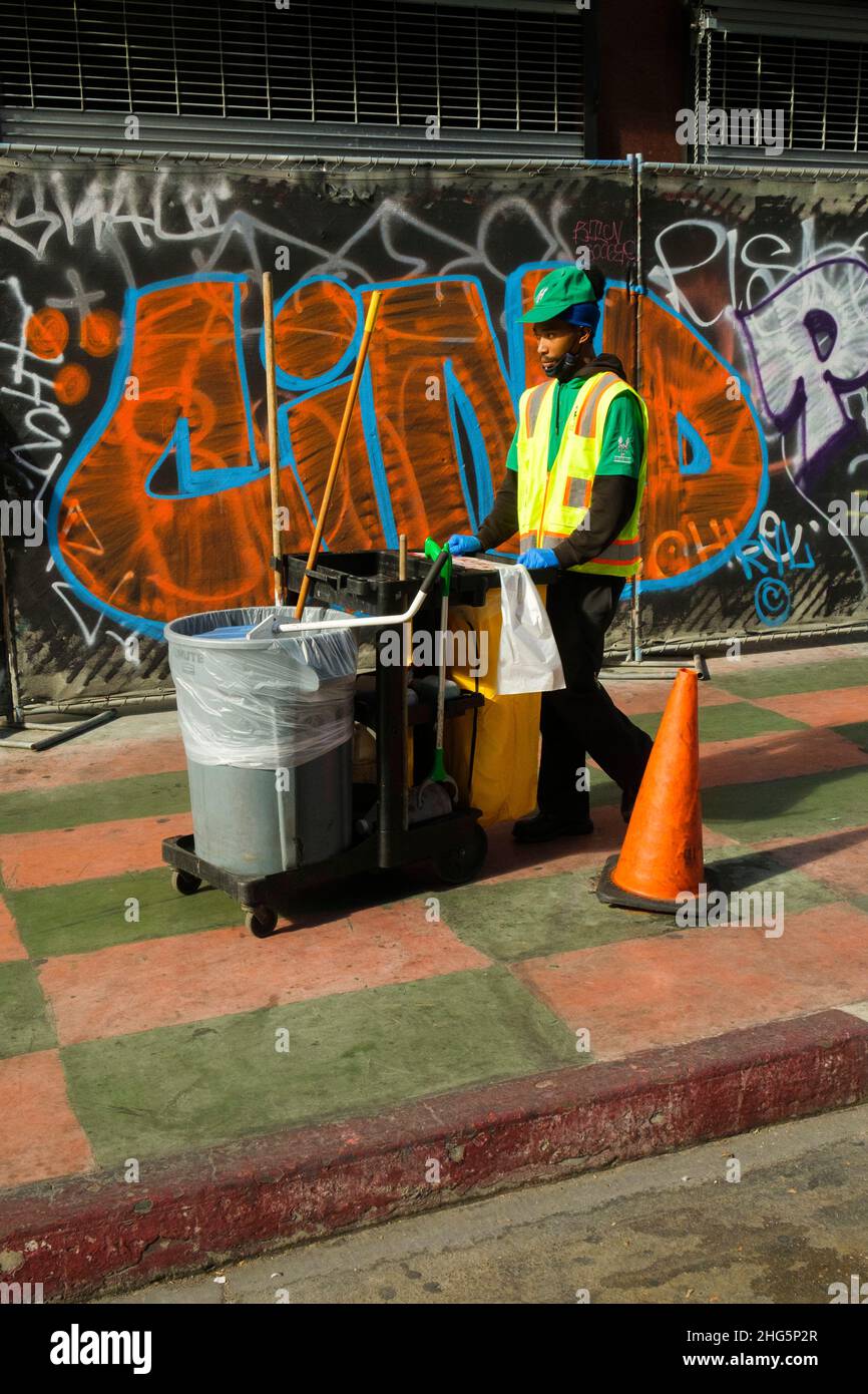 Cleaning the streets, a worker. Broadway, Downtown Los Angeles ...