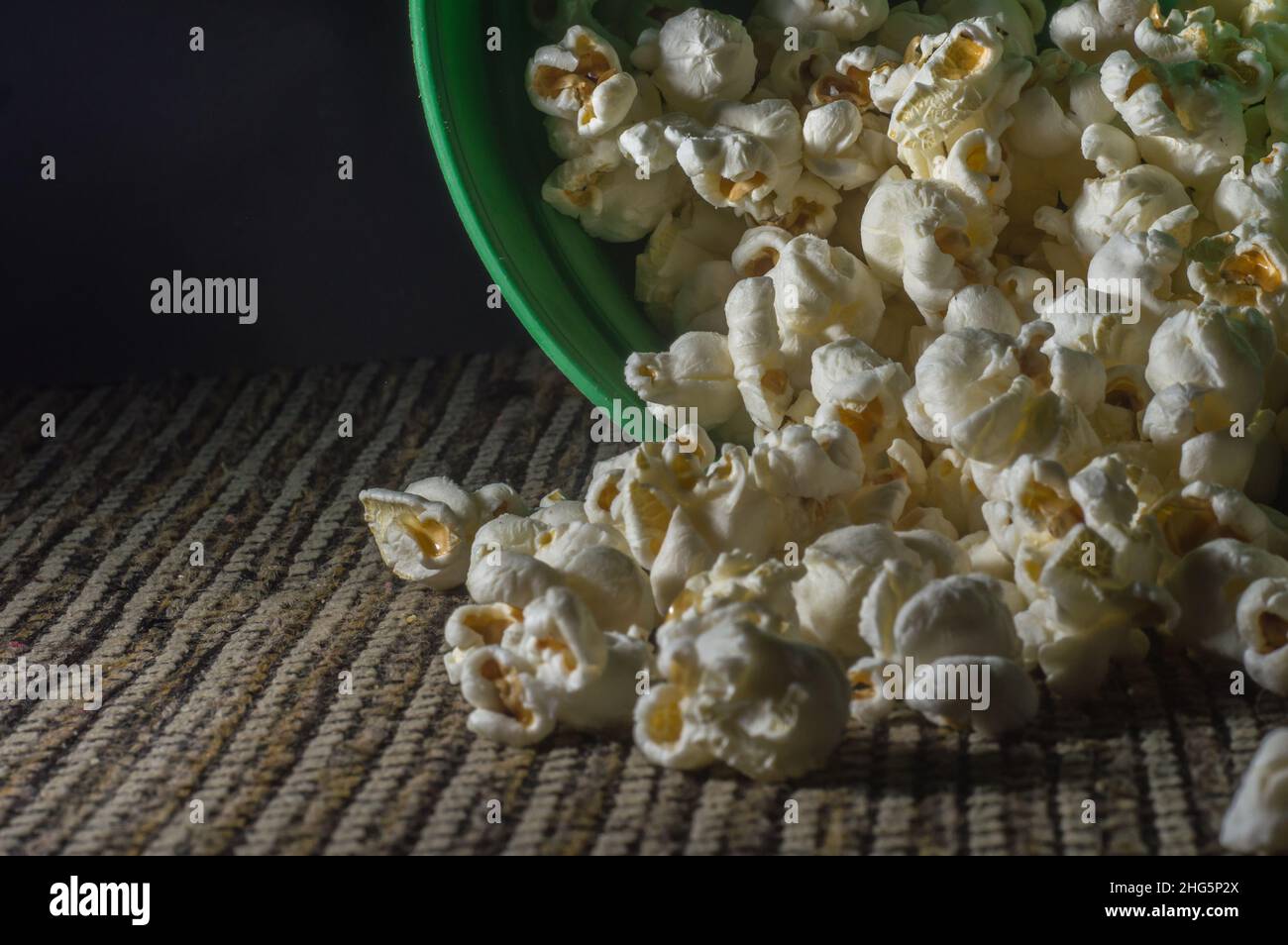 popcorn dropped on the sofa with copy space and dark background Stock ...