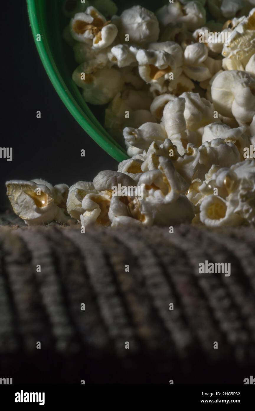 popcorn dropped on the sofa with copy space and dark background Stock ...