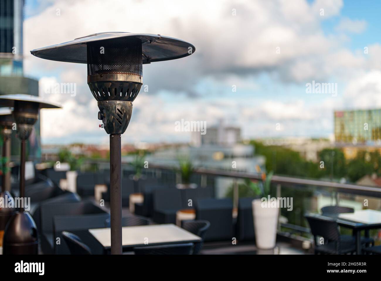 Stainless stand up outdoor gas heater in cafe Stock Photo - Alamy
