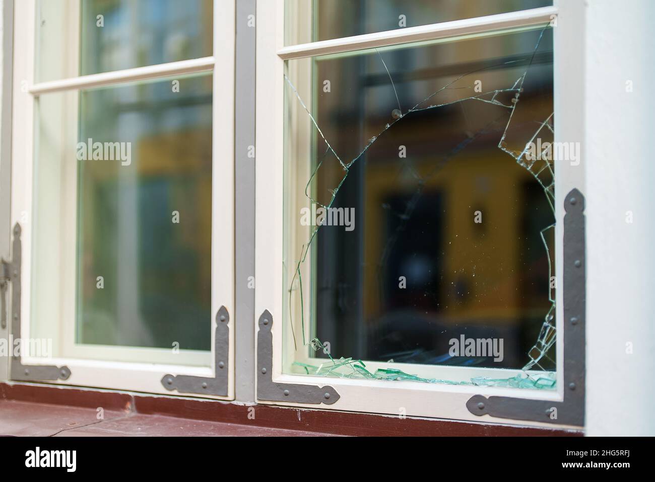 Broken window in the house. Vandalism and pogroms Stock Photo - Alamy