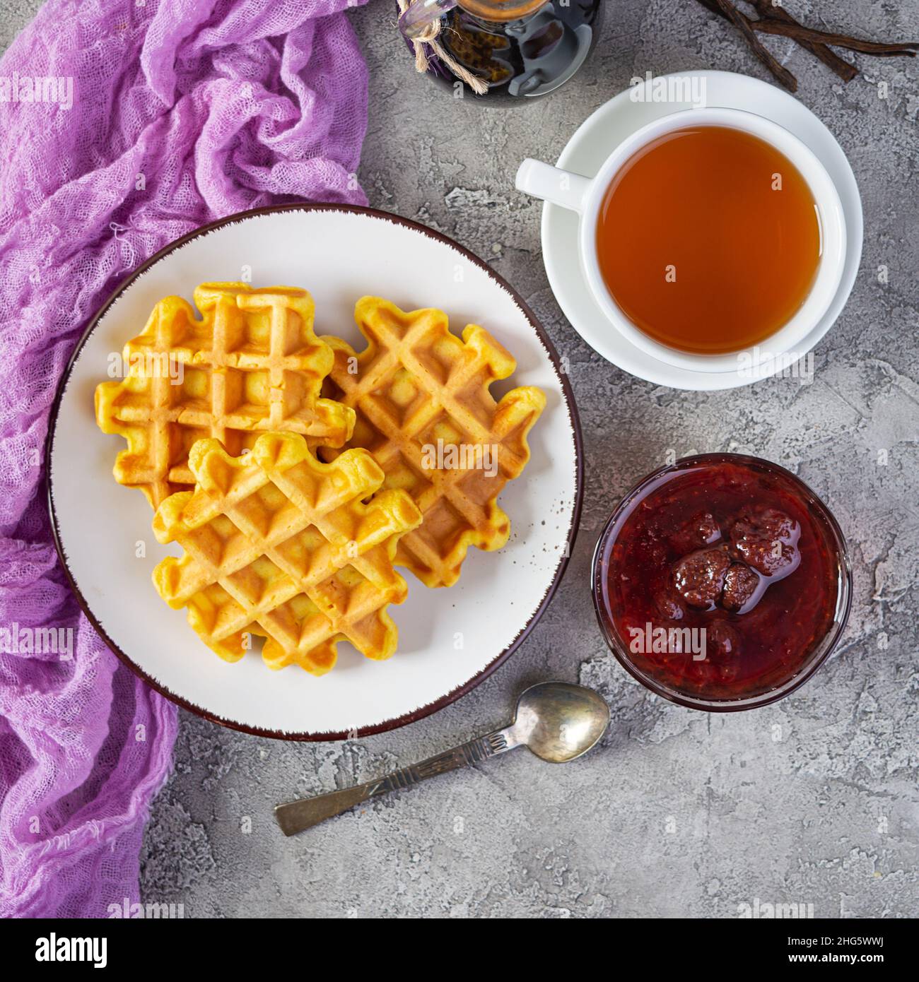 Sweet pumpkin waffles with strawberry jam. Delicious breakfast with ...