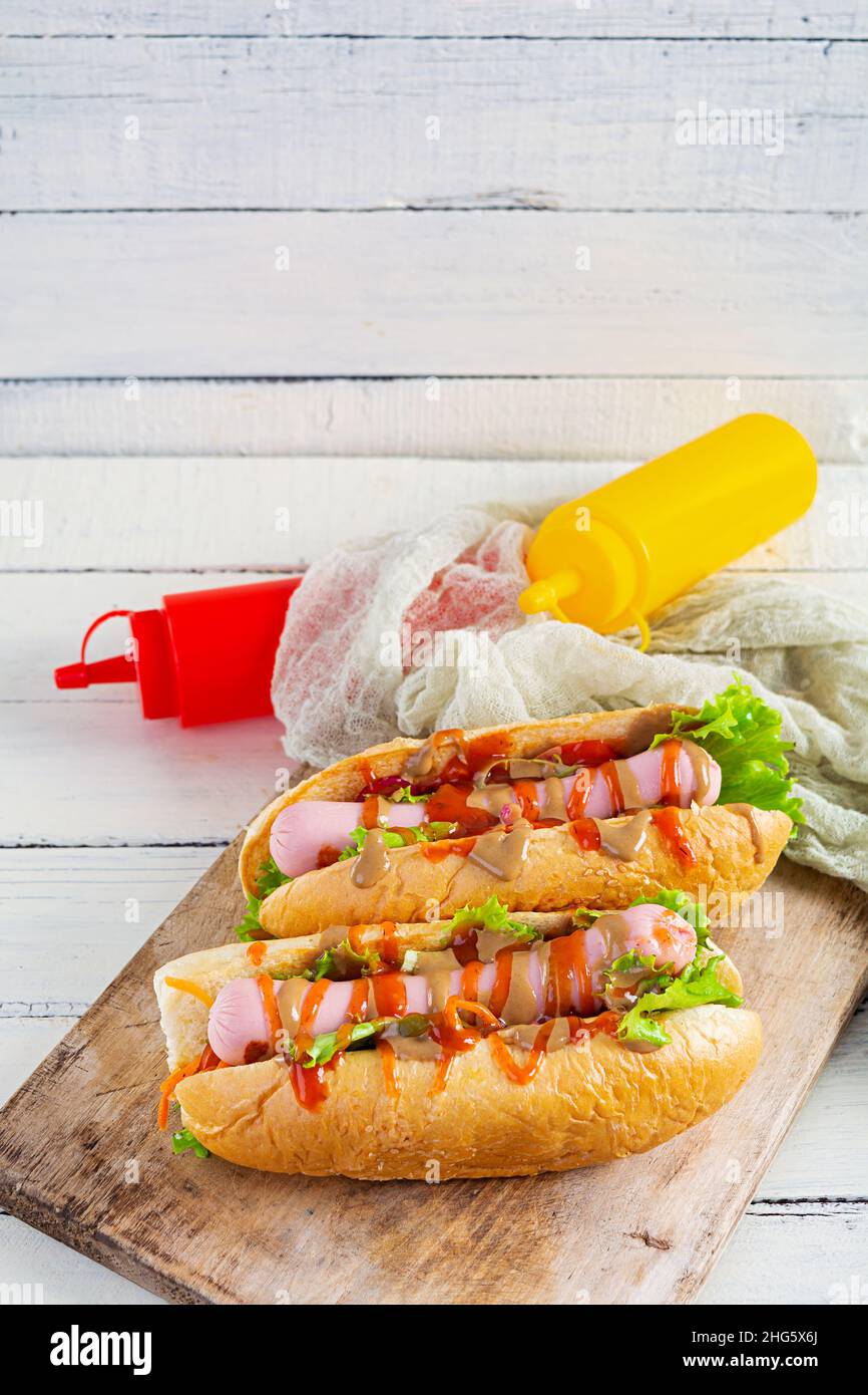 Delicious hot dog with ketchup and mustard on wooden background. Street ...