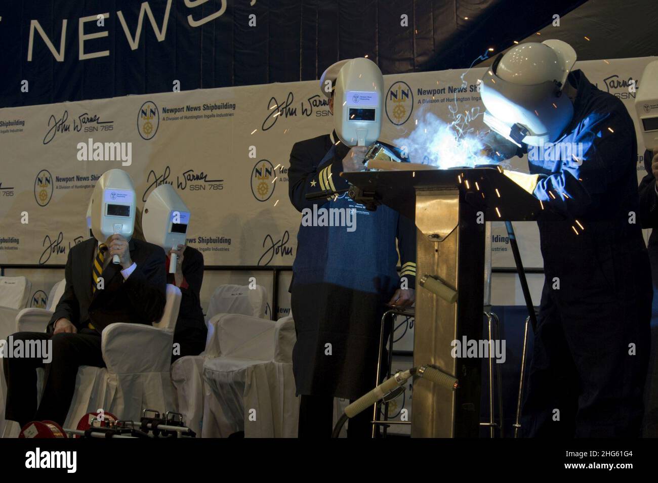 Sen. John Warner's initials are welded during the keel laying ceremony ...