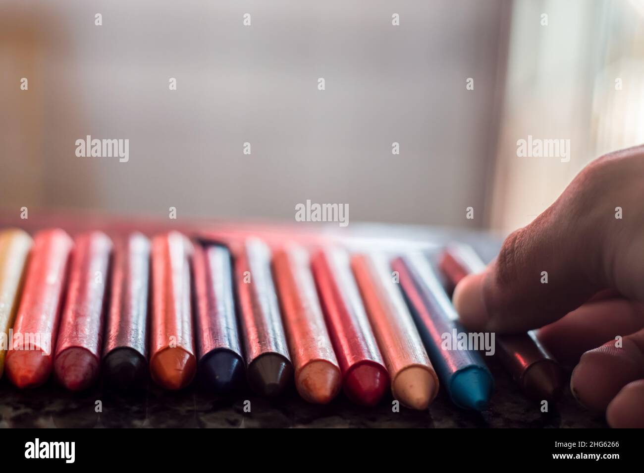 Focused crayon color diversity and hand picking up a brown crayon ,copy ...