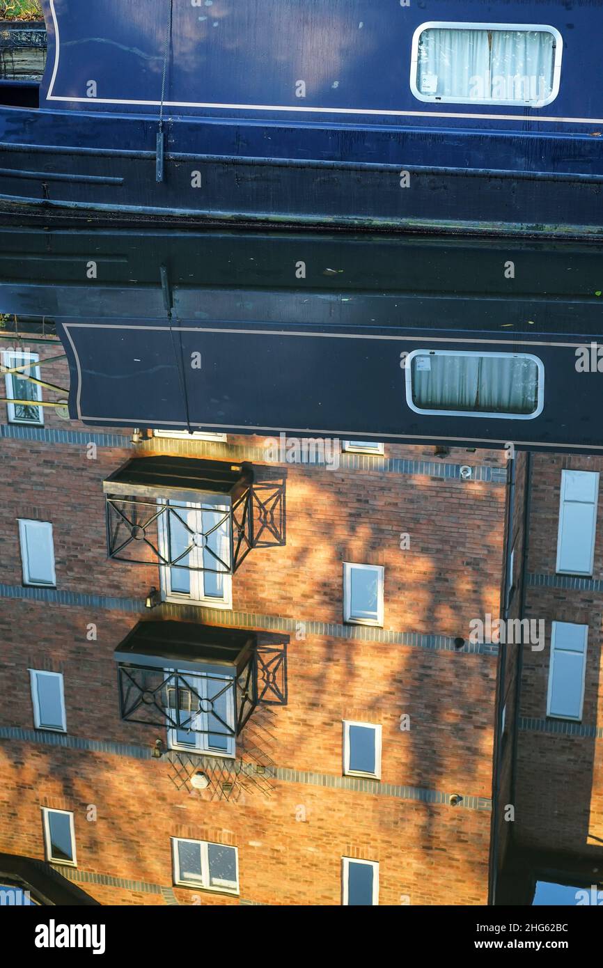 Upside down reflection in canal water of trendy, waterside apartment ...